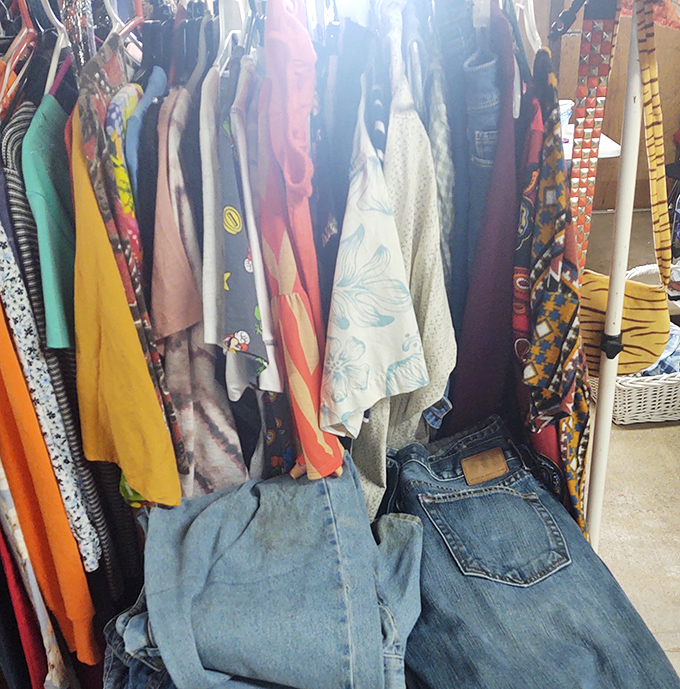 The clothing racks&mdash;a textile rainbow where vintage Levi's hang next to forgotten prom dresses, each waiting for their fashion resurrection moment.