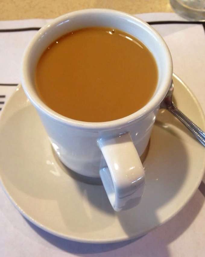 Coffee served in the classic white diner mug—the vessel that's launched a thousand conversations and saved countless Monday mornings.