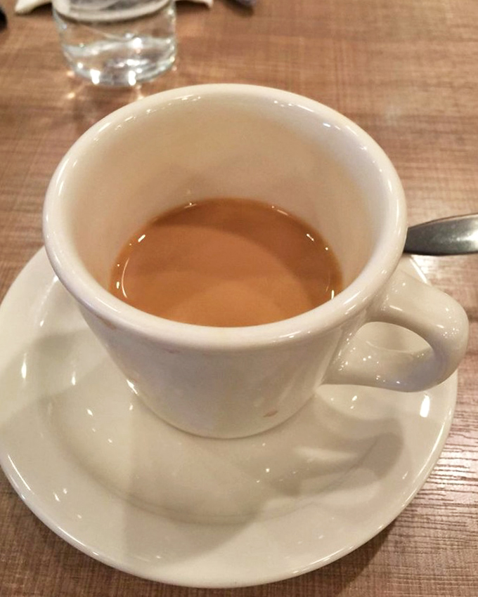 A proper cup of coffee: dark as midnight, smooth as jazz, and essential as the air we breathe before noon.