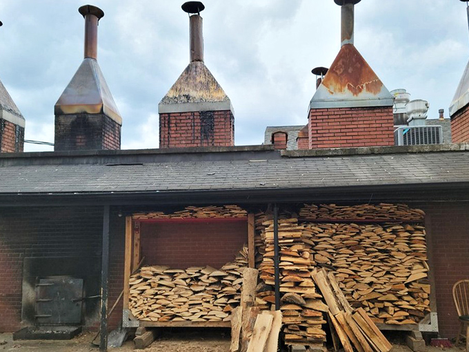 The smoke stacks and woodpile&mdash;barbecue's engine room. This is where the magic begins, with hickory logs transforming into flavor that defies explanation.