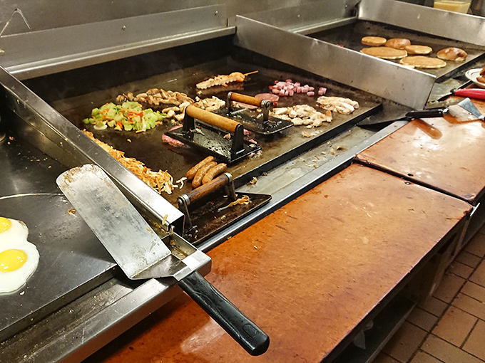 The cooking area buzzes with activity as breakfast items sizzle across the griddle, creating that symphony only diners understand.