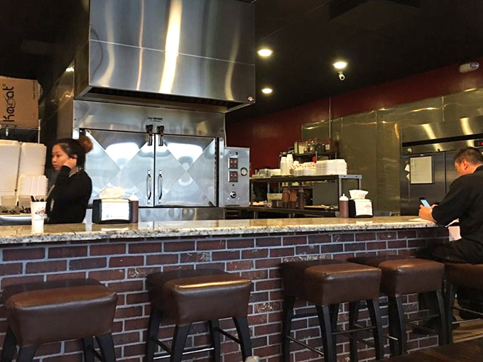 Behind this counter, barbecue science happens daily. The stainless steel and brick blend tradition with modern technique.