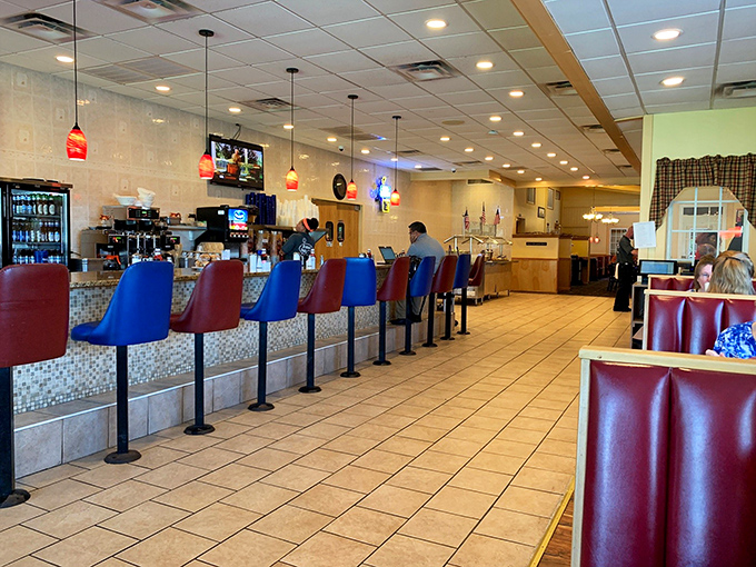 Classic counter seating with colorful stools invites solo diners to enjoy a meal while watching the choreographed dance of diner service.