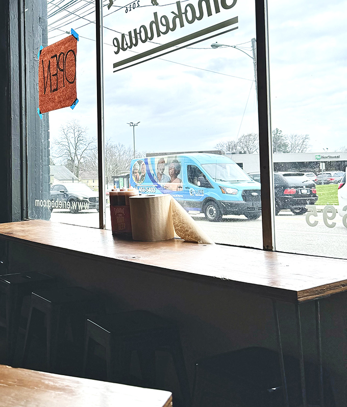 Window seating offers prime people-watching, though most eyes remain fixed on the barbecue masterpieces commanding attention at each table.