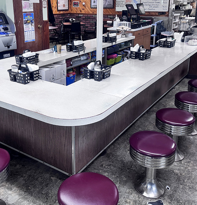 Classic counter seating with purple vinyl stools &ndash; where solo diners become temporary family and waitresses remember your order before you sit down.