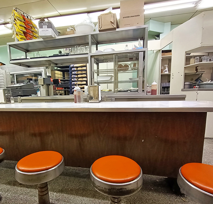 Counter stools where countless Detroiters have perched, pondering life's big questions over chili dogs.