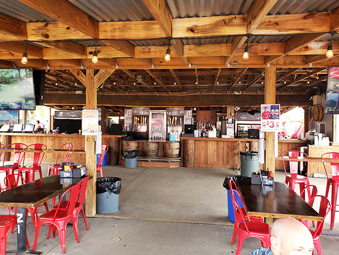 Rustic meets relaxed in this covered patio space. Red metal chairs pop against wooden beams, creating a casual vibe that says "stay awhile."