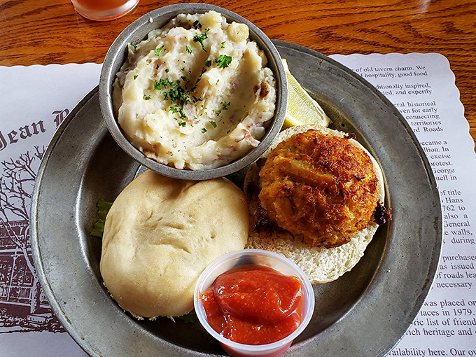 A crab cake sandwich that doesn't skimp on the star ingredient, paired with mashed potatoes that could make a Frenchman question his loyalty to pommes pur&eacute;e.