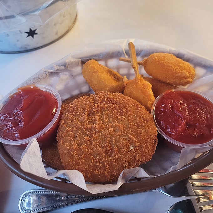 A crab cake surrounded by dipping sauces&mdash;the seafood equivalent of a celebrity with an entourage, and every bit as impressive.