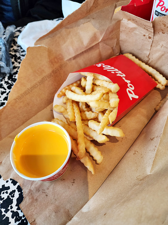 Crinkle-cut fries with liquid gold cheese sauce&mdash;proof that sometimes the side dish can steal the spotlight from the main attraction.