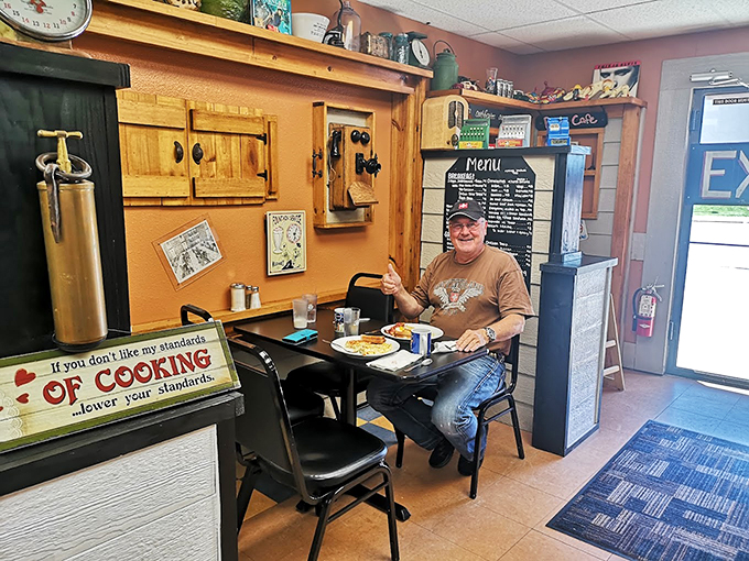 Every great caf&eacute; has that one corner where regulars hold court. This gentleman has clearly found his happy place&mdash;fork in hand, breakfast before him.