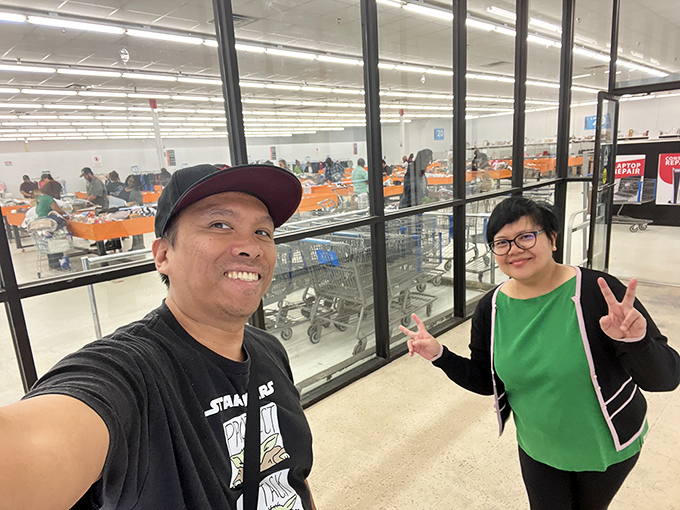 Happy shoppers flashing victory signs&mdash;the universal gesture that says "We conquered the bins and our wallets survived to tell the tale."