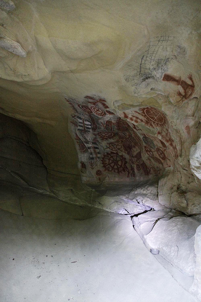 The cave's interior reveals a complex tapestry of symbols&mdash;sunbursts, anthropomorphic figures, and geometric patterns that have sparked archaeological debate for decades.