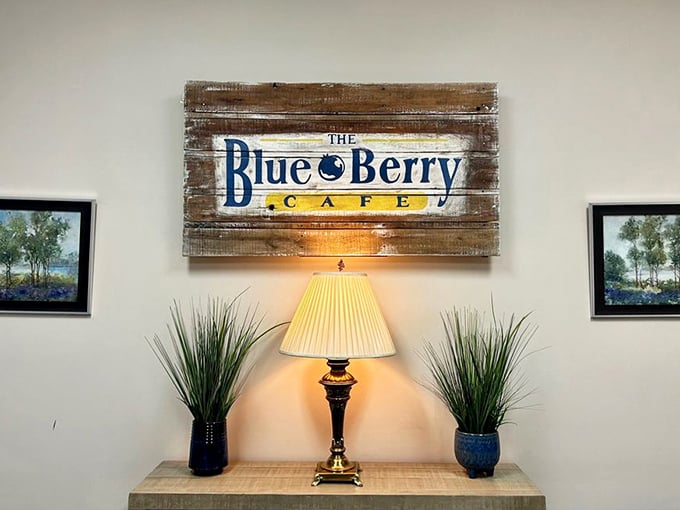 The rustic wooden sign serves as a beacon of breakfast hope, flanked by plants that have witnessed countless pancake revelations.