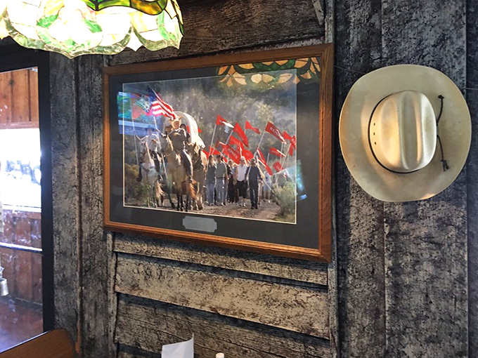 Patriotic artwork and a cowboy hat adorn the rustic walls, creating an atmosphere where American comfort food feels right at home.