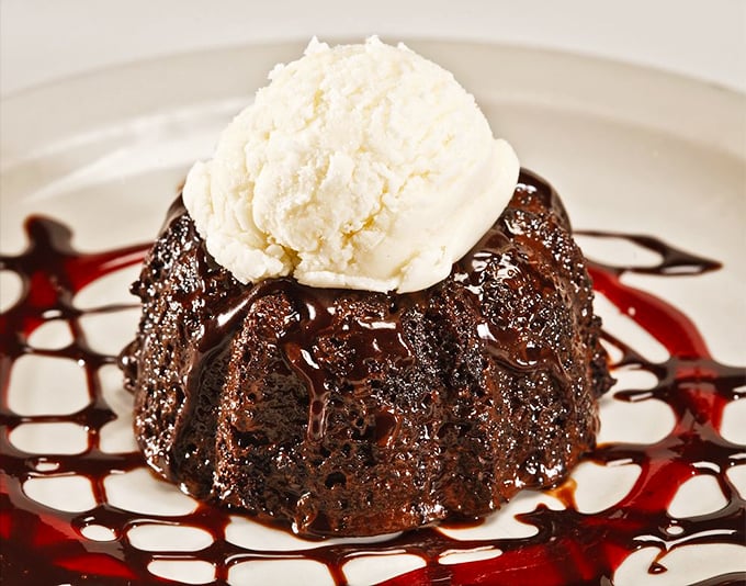 A chocolate dessert that's basically wearing a tuxedo. The vanilla ice cream is melting into the warm cake like it's coming home.