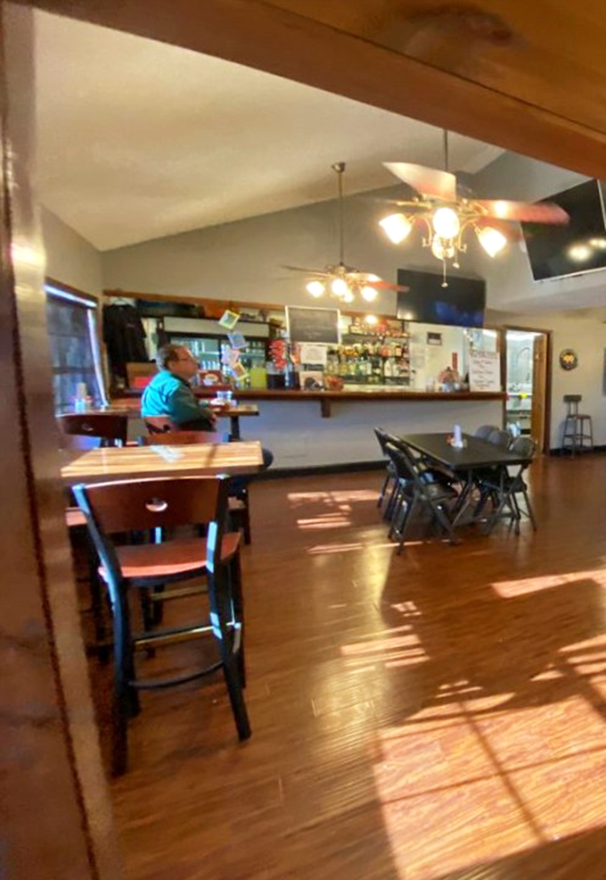 Sunlight streams across wooden floors while a patron enjoys the quiet satisfaction that only comes from knowing great BBQ is moments away.