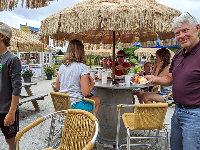 Multi-generational dining under thatched umbrellas – creating memories that will last longer than your sunburn.