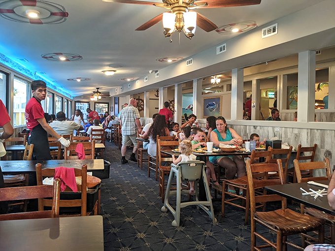 Happy diners enjoying the fruits of the sea in comfortable surroundings. The bustling atmosphere speaks to the universal truth: good seafood brings people together.