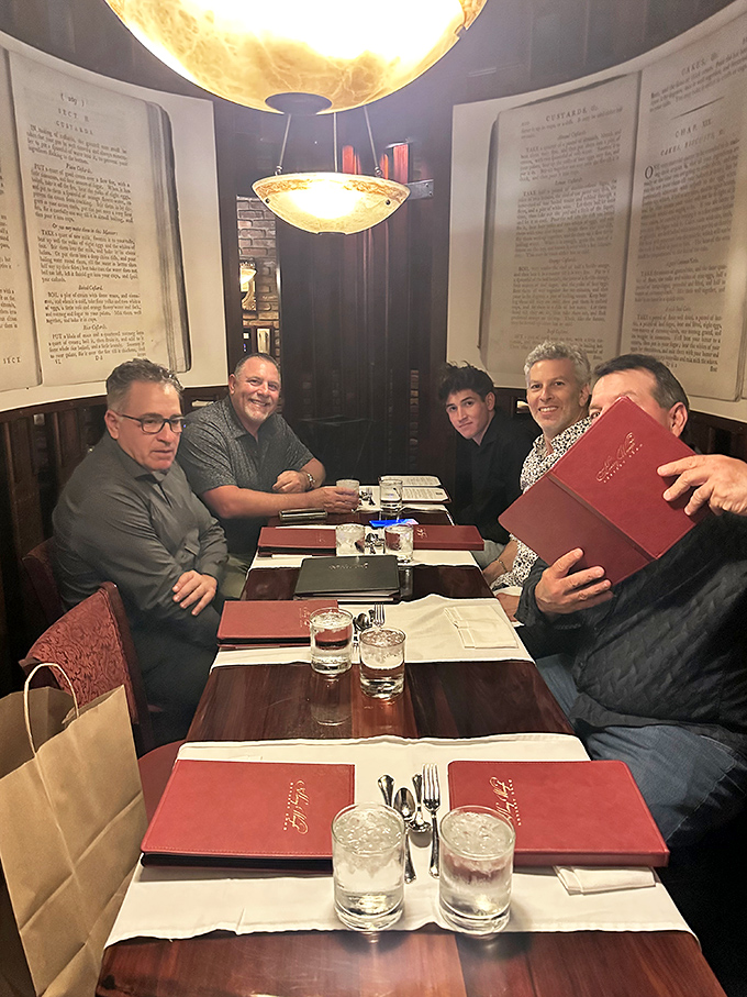 A gathering of friends enjoying the timeless pleasure of breaking bread together in surroundings that feel both special and comfortable.