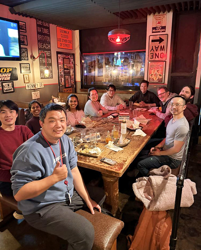 Happy diners gathered around a communal table &ndash; the universal sign of food worth sharing. These smiles weren't practiced; they were earned by exceptional eats.