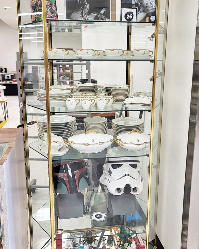 Fine china displayed in a glass cabinet alongside Star Wars collectibles &ndash; where grandma's formal dinnerware meets nerd culture in perfect harmony.