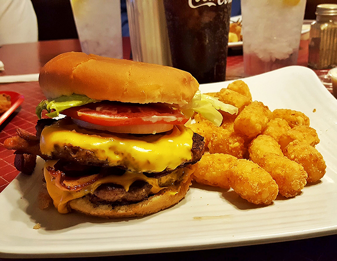 This isn't just a burger; it's an engineering marvel of beef, cheese, and toppings that somehow maintains structural integrity until the final bite.