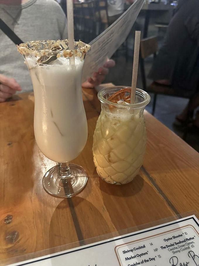 Cocktails that make you forget to check your phone. The tropical concoctions arrive in vessels that telegraph vacation mode before the first sip.