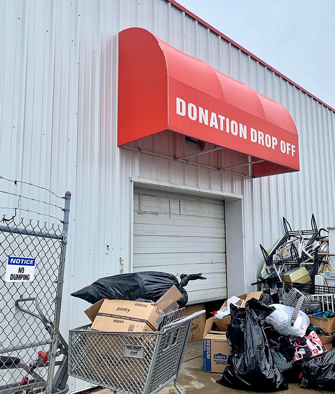 The donation drop-off: where yesterday's impulse purchases become tomorrow's treasures. The circle of retail life continues under the red awning.