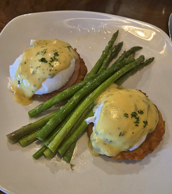 Eggs Benedict that transforms breakfast into an event. Those perfectly poached eggs perched on crab cakes instead of English muffins? Pure genius.