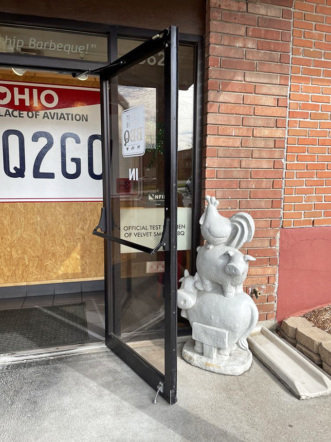 A whimsical farm animal statue welcomes you inside, adding personality to this serious BBQ operation with delightful contradictions.