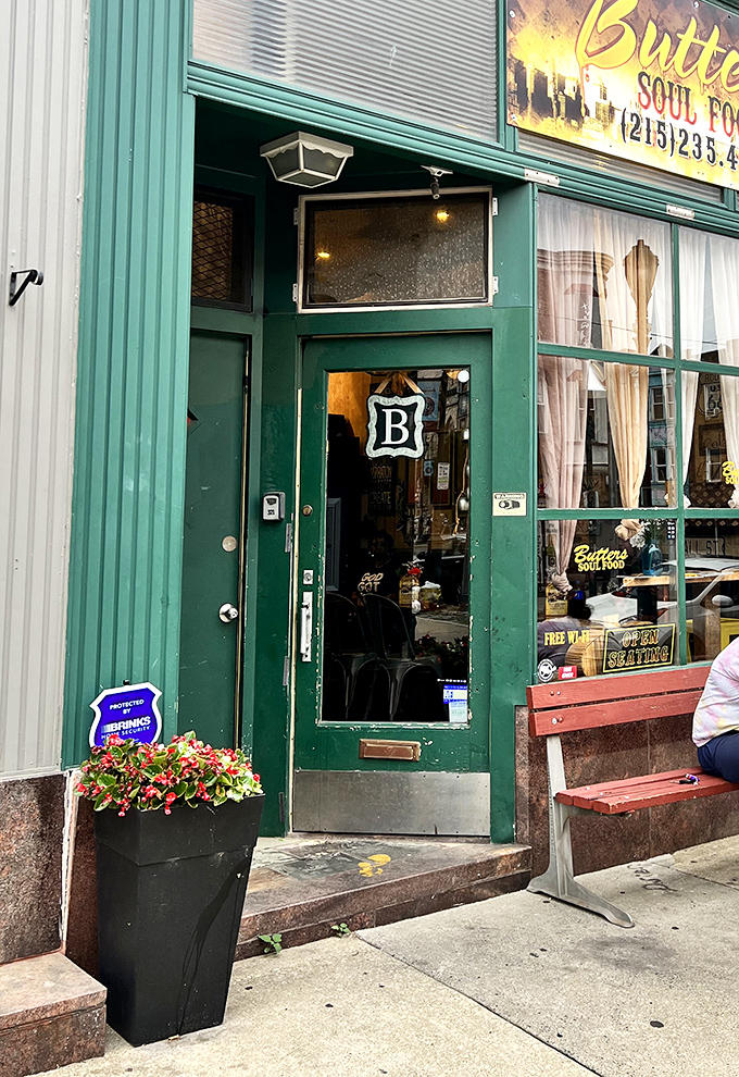 The entrance beckons with its distinctive "B" emblem and potted flowers. Like the culinary equivalent of a welcome mat.