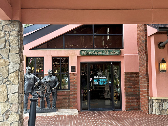 The entrance to the Waterfront Market stands ready, flanked by bronze seafarers who seem to say, "Trust us, the fish inside is worth the journey."