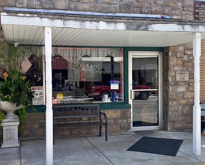 An entrance framed by planters and pride, inviting you to discover what all the local buzz is about.
