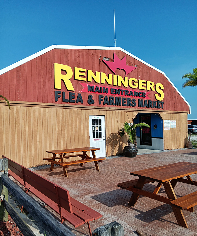 The barn-red entrance with its crown logo promises royal treatment for commoner budgets. Those picnic tables invite you to rest before or after the treasure hunt.
