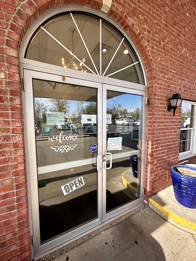 That arched doorway welcomes you inside, where the word "welcome" on the glass is wonderfully redundant but genuinely meant.