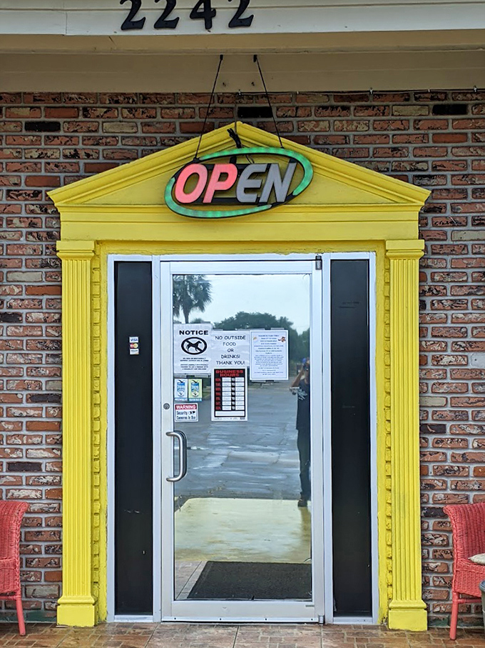 The bright yellow entrance frame and neon "OPEN" sign &ndash; like a beacon of breakfast hope in a sea of chain restaurants and green smoothie shops.
