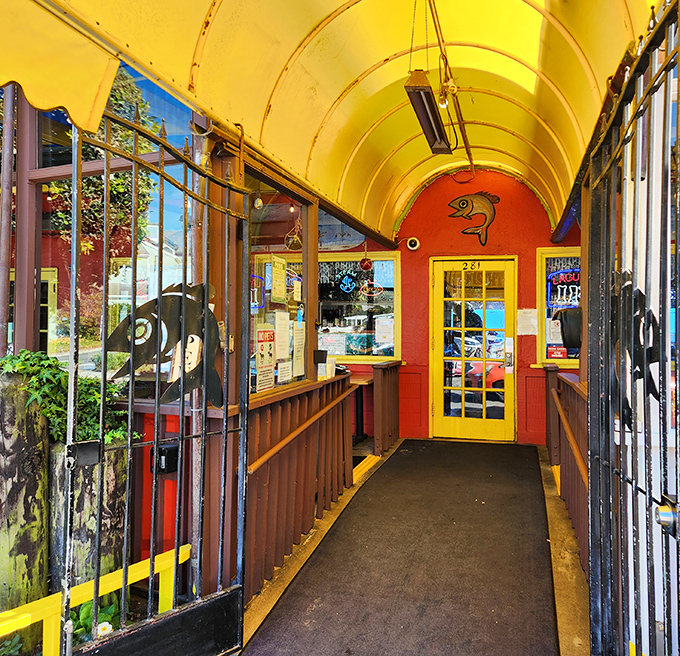 The entrance tunnel's vibrant yellow ceiling and fish motifs set the stage&mdash;you're not just entering a restaurant, you're embarking on a seafood adventure.