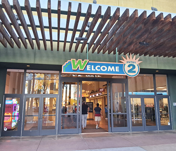 Entrance number two welcomes shoppers with a cheerful sign that might as well say, "Yes, there's another wing of stores your wallet hasn't seen yet."