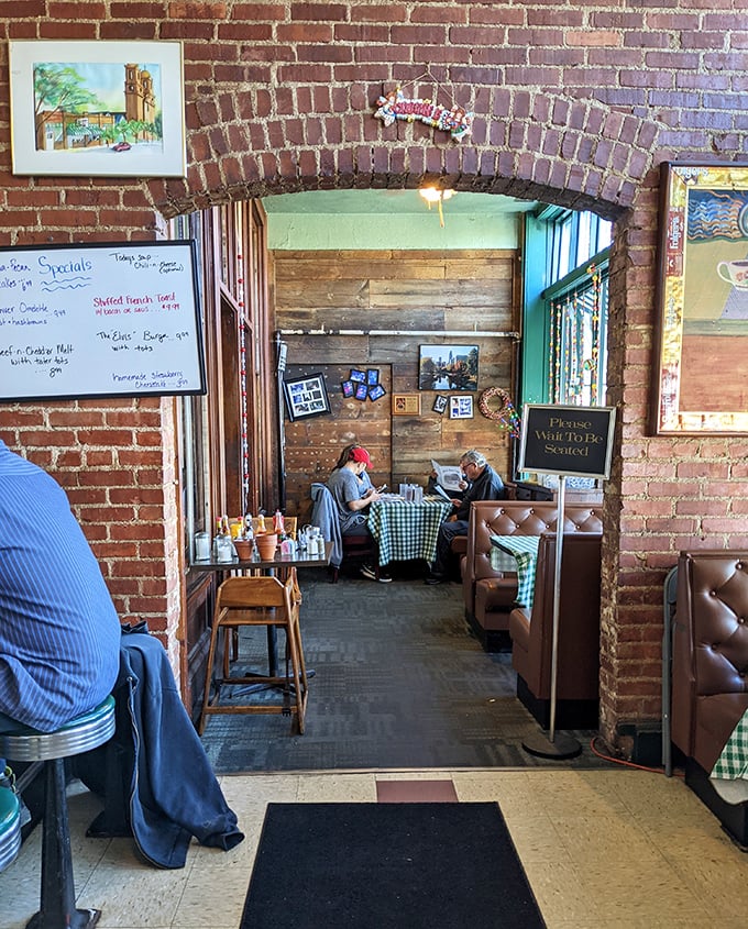 The brick archway separates dining areas like chapters in a good book. Each section of Lisa's tells its own story while contributing to the overall narrative of comfort.