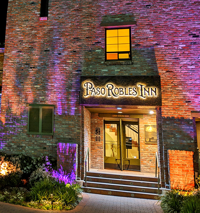 The illuminated entrance to Paso Robles Inn glows with promise as evening falls &ndash; a beacon for hungry travelers and locals alike.