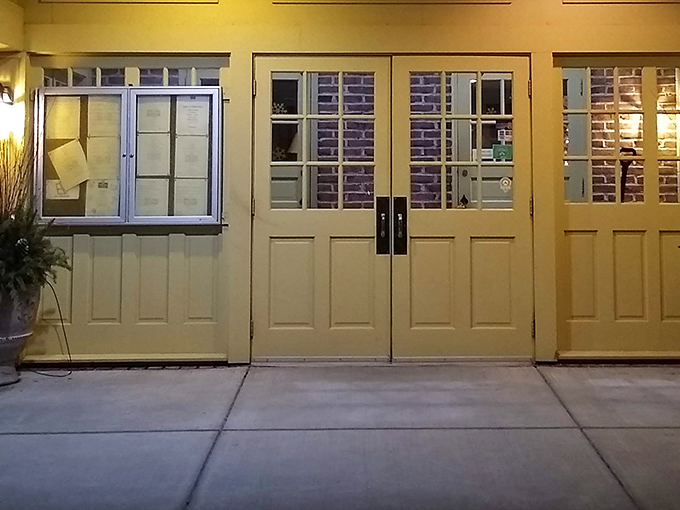 As evening falls, the tavern's entrance glows with warm invitation. Those cream doors promise refuge from the outside world and delicious possibilities within.