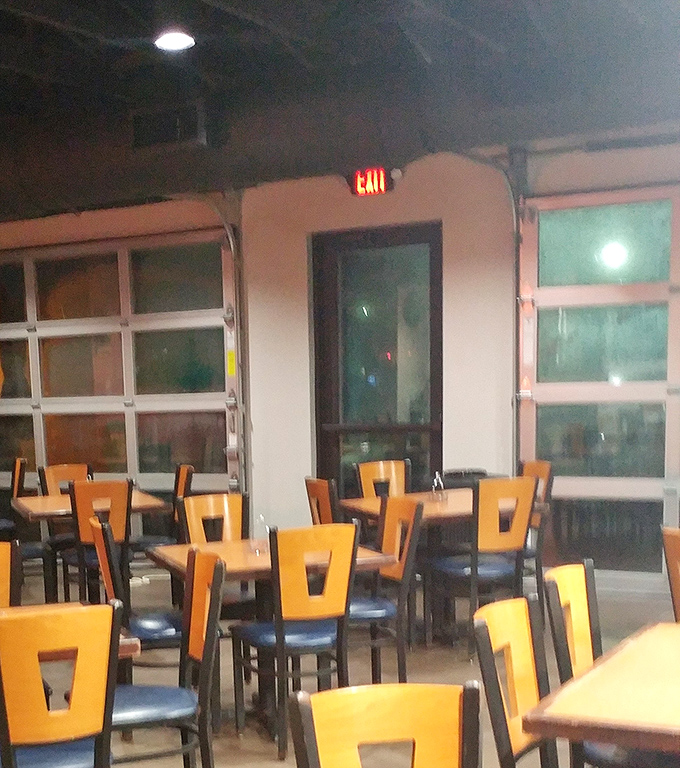 Simple wooden chairs and tables await beneath exposed ductwork &ndash; because when the food is this good, fancy chandeliers would just be showing off.