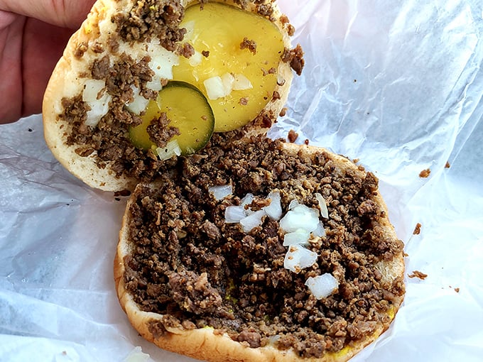 Open the sandwich to reveal the secret&mdash;perfectly seasoned meat crumbles mingling with diced onions and pickle slices.
