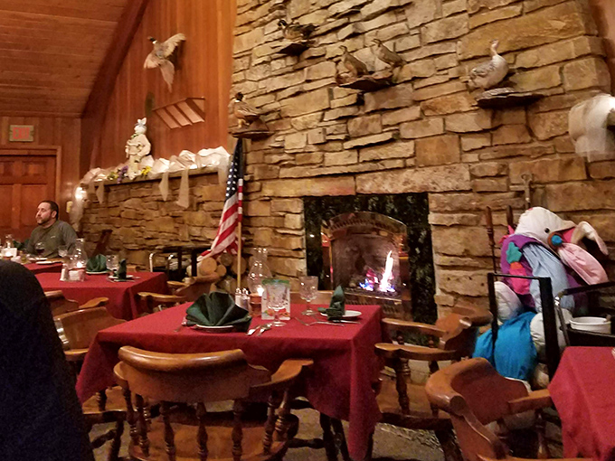 A stone fireplace adds rustic warmth to the dining room, perfect for lingering over dessert on chilly nights.
