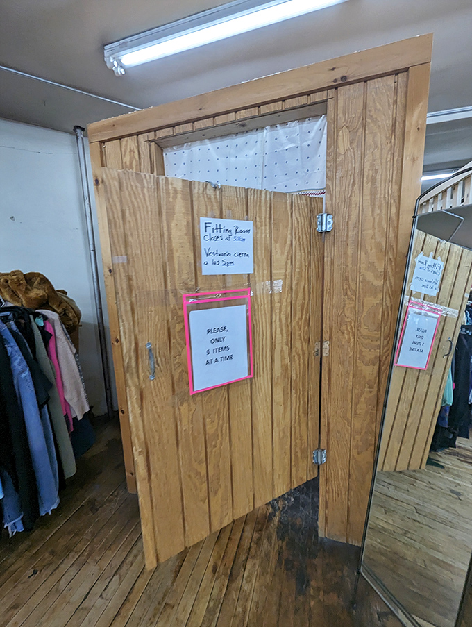 "Only 5 items at a time" reads the fitting room sign, a gentle reminder that enthusiasm must sometimes be tempered with patience.