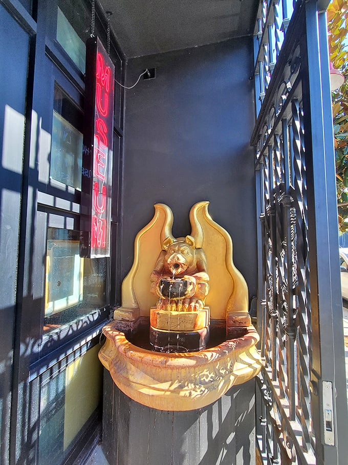 A small fountain near the entrance offers an unexpected moment of serenity before the macabre journey begins.