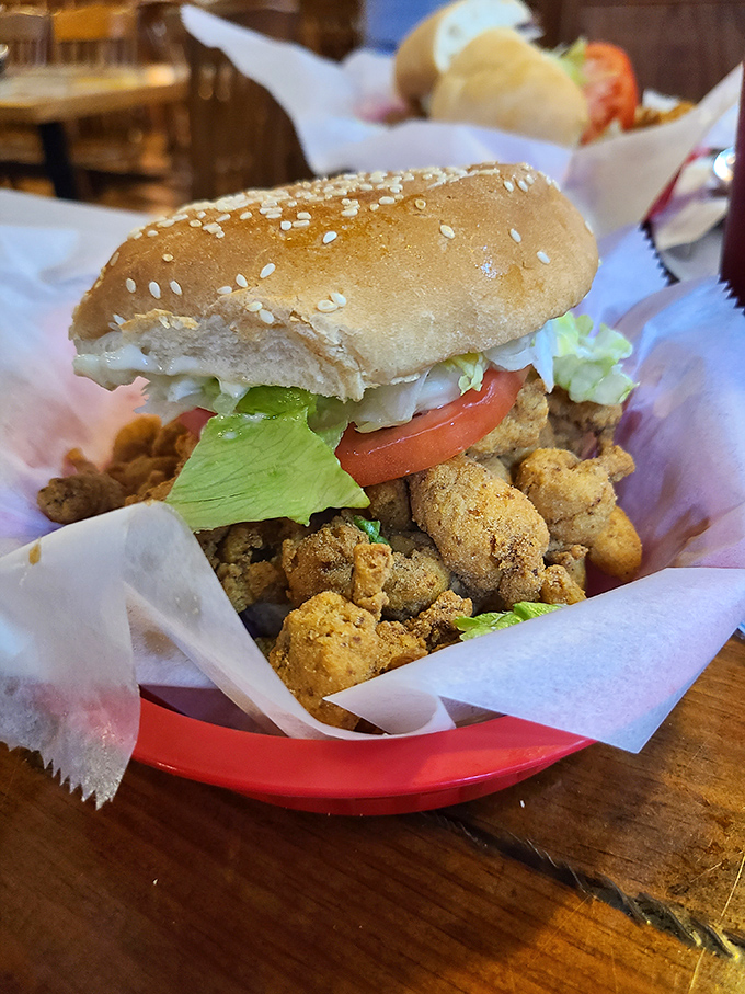 This isn't just a sandwich&mdash;it's an engineering marvel of fried oysters, fresh veggies, and bread that somehow contains the delicious chaos.
