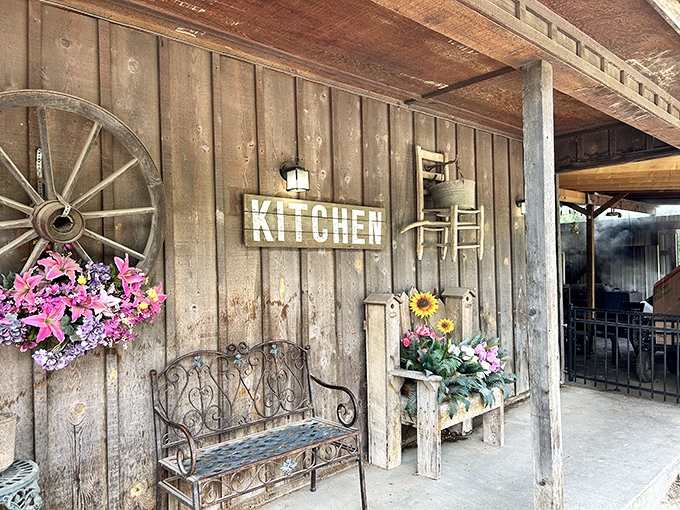 The porch welcomes weary travelers with country charm &ndash; wagon wheel, wrought-iron bench, and flowers that seem to say, "Slow down, you're home now." 