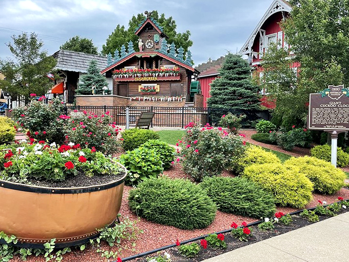 The clock's surrounding garden bursts with color, creating a frame of natural beauty that makes even non-photographers reach for their phones.